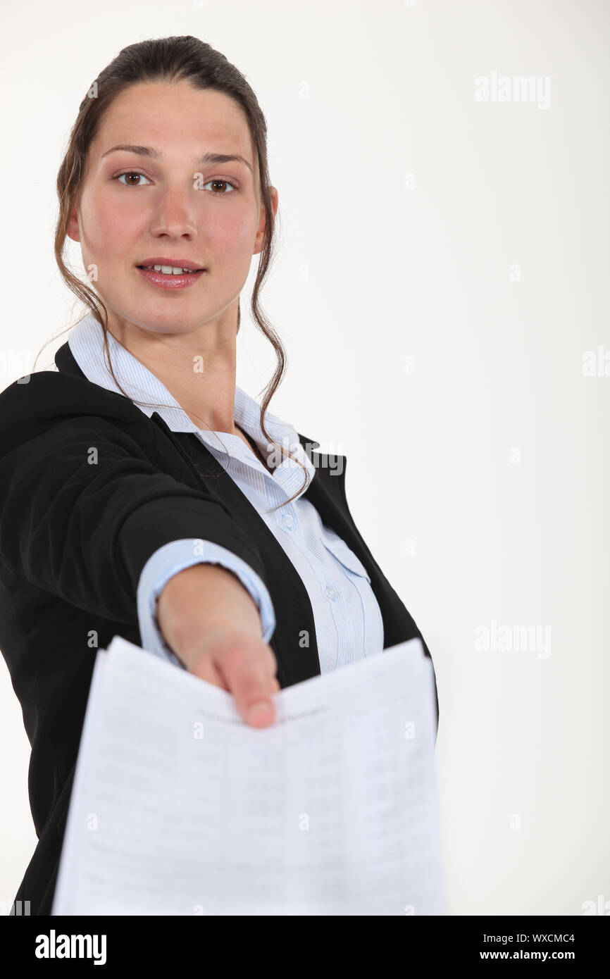 Woman handing over completed paperwork Stock Photo - Alamy