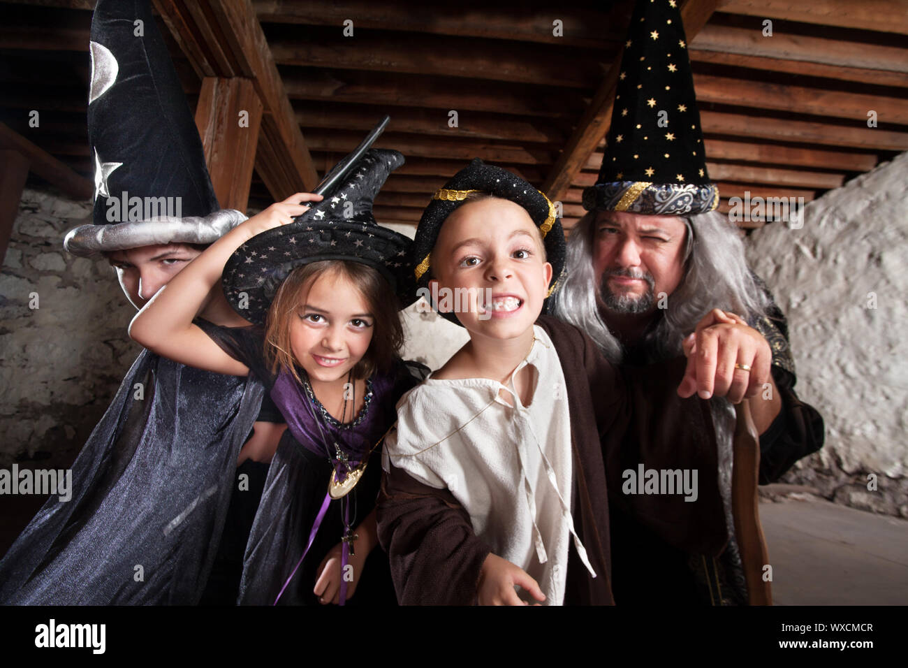 Happy family of sorcerers together indoors Stock Photo - Alamy