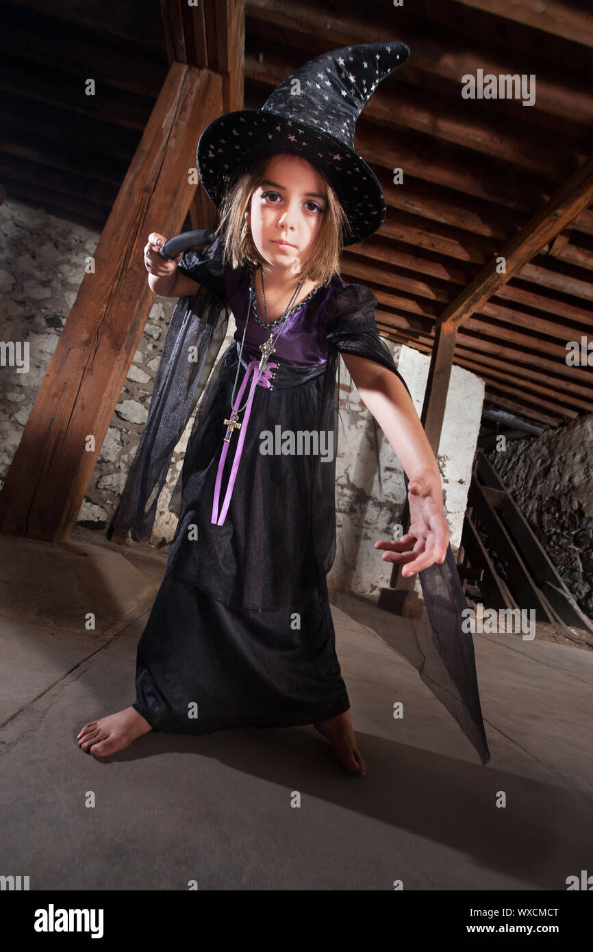 Serious female European child witch pointing her magic staff Stock ...