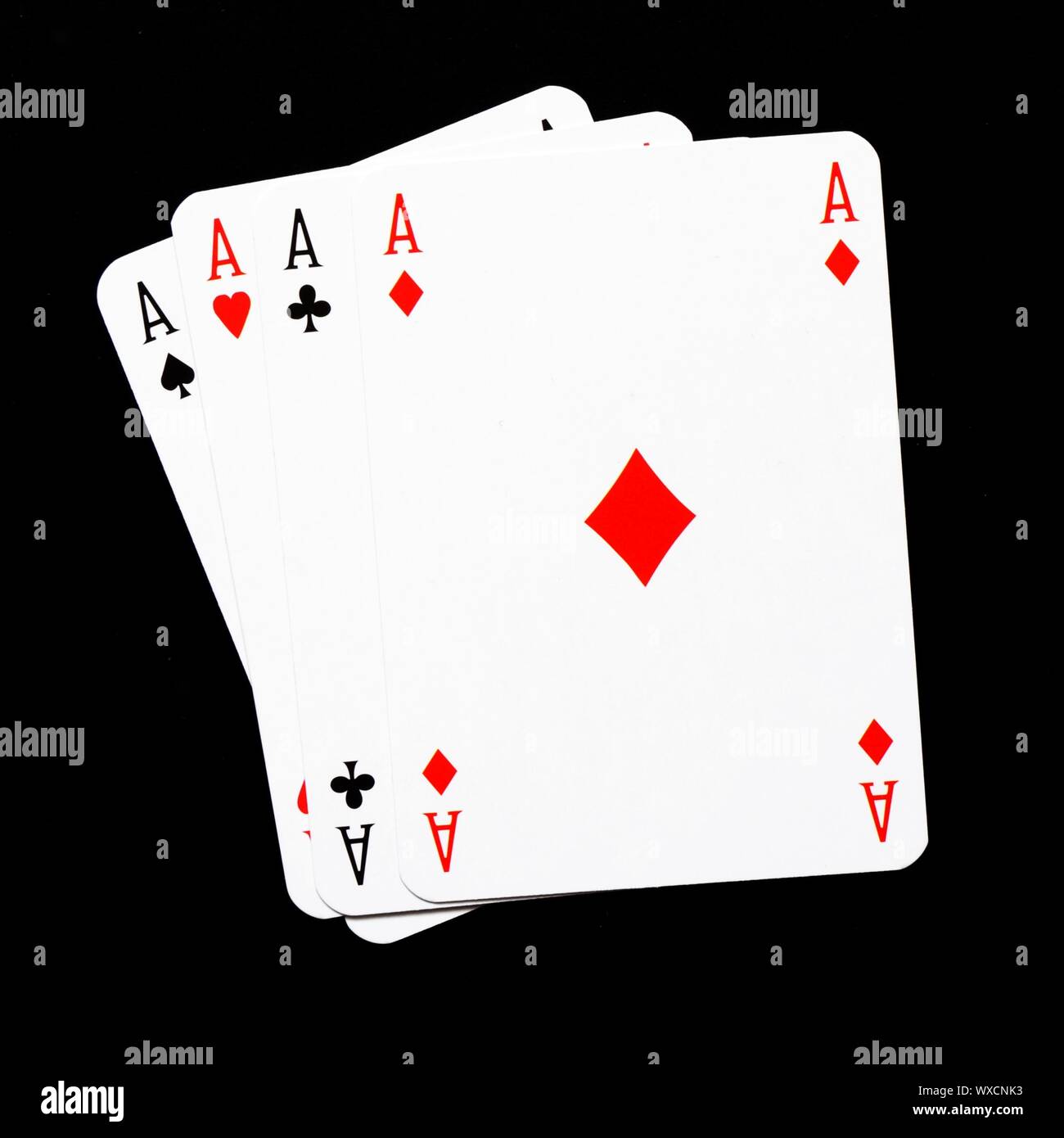 card game with aces on black background Stock Photo - Alamy