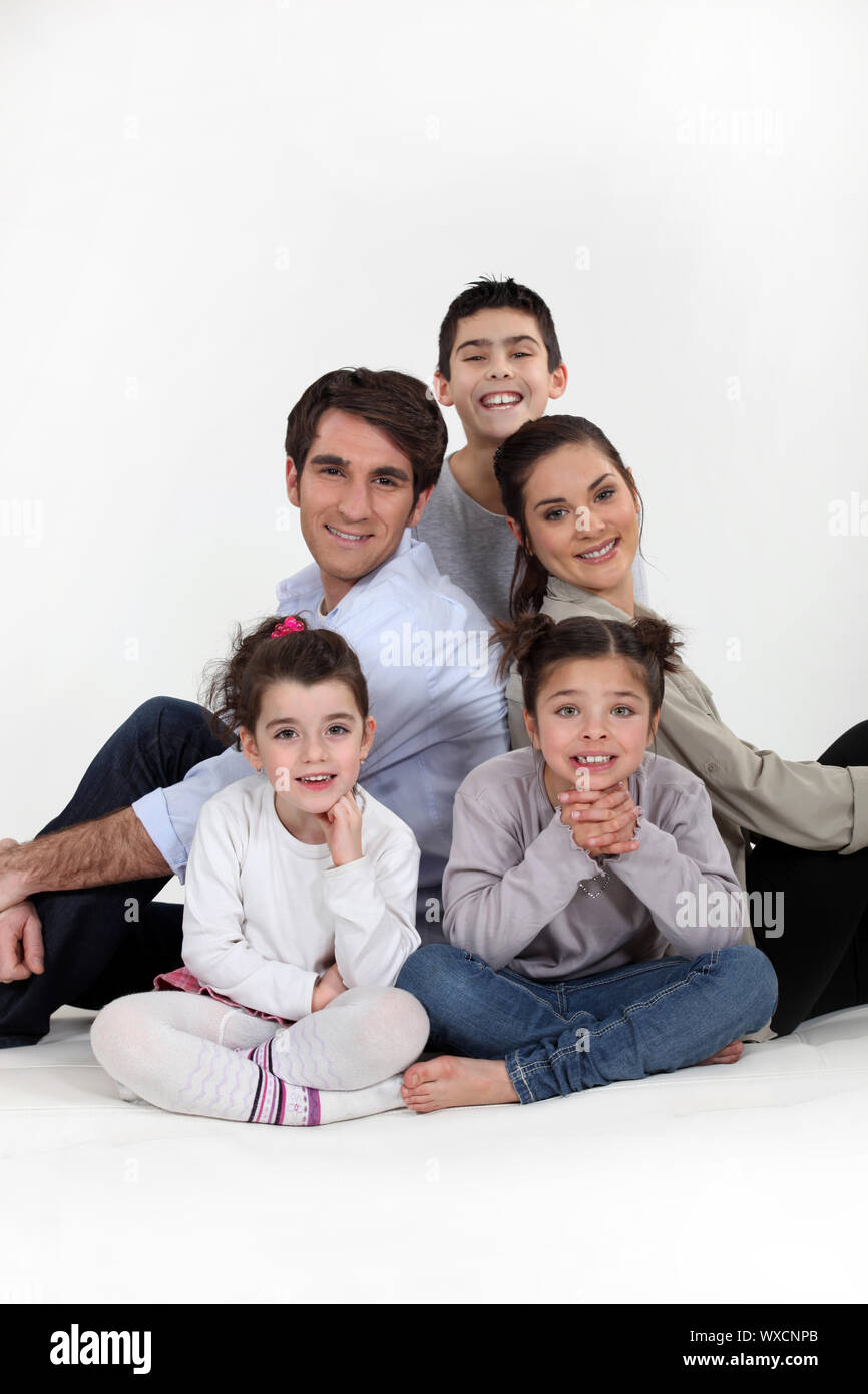 Parents and three children sat together Stock Photo - Alamy