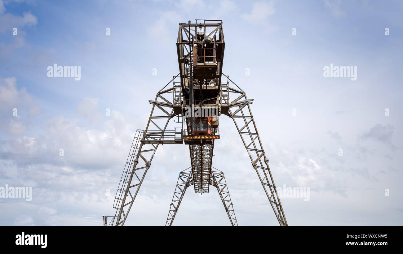 Large metal gantry cranes at a construction site against the blue sky ...