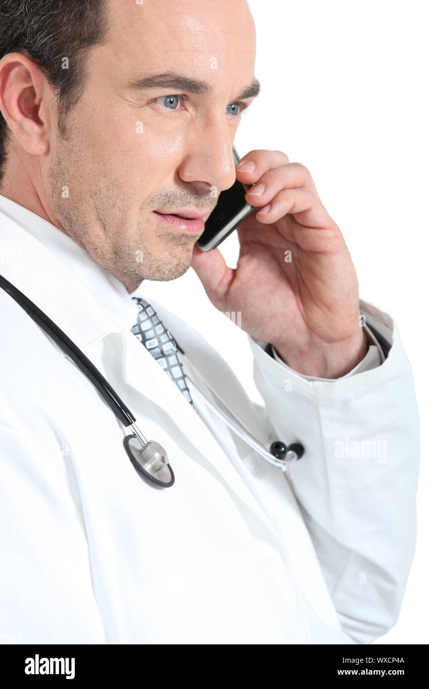 Doctor on phone smiling Stock Photo - Alamy