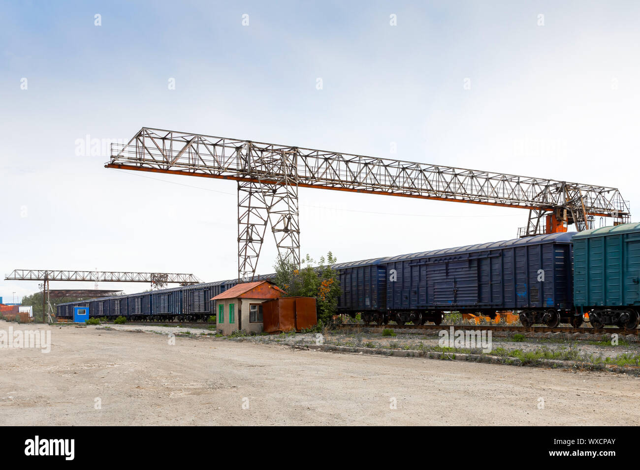 Large metal gantry cranes at a on the railway platform, standing on ...