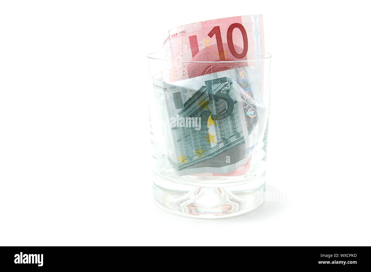 Some euro banknotes in a tumbler isolated on white background Stock ...