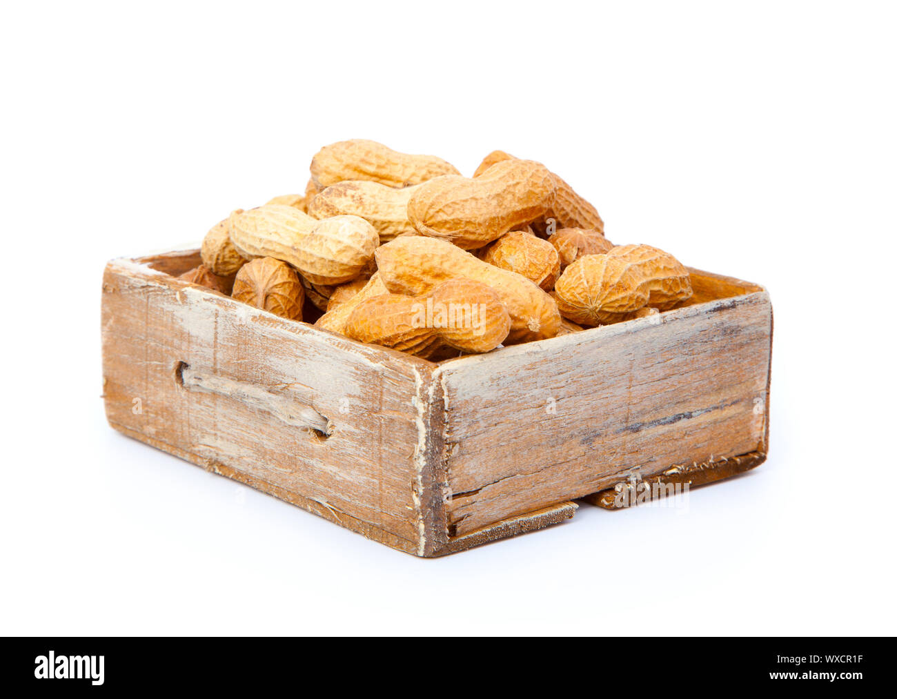 Peanuts in the old box, on white background Stock Photo - Alamy