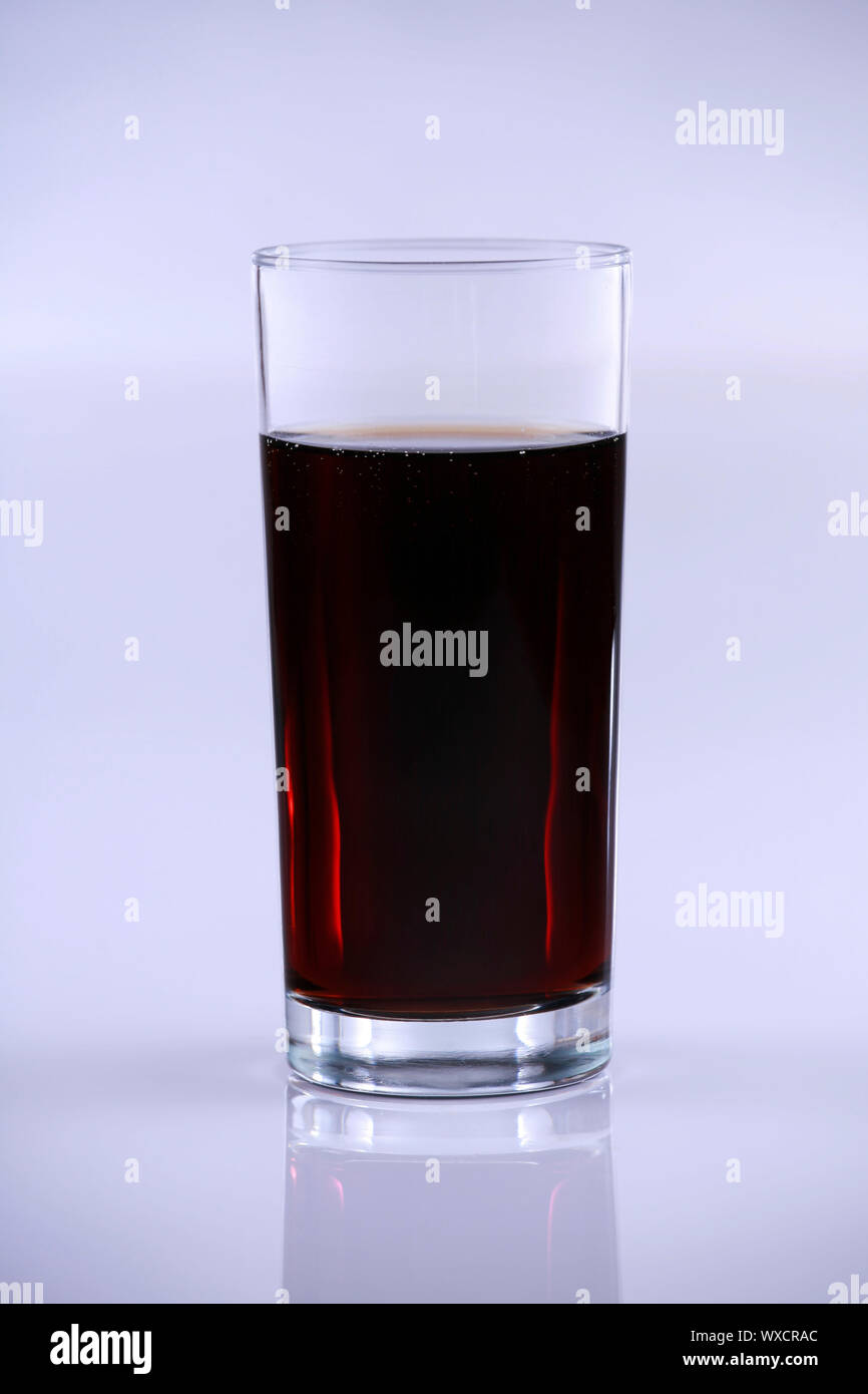 Soda pop in tall glass with blue tones in background Stock Photo - Alamy