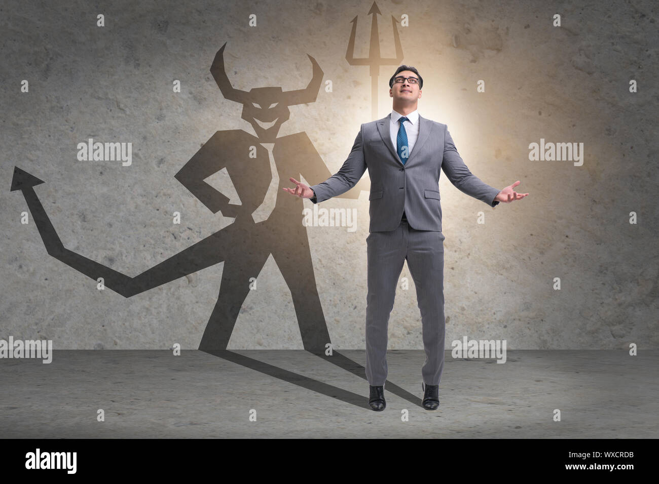 Devil hiding in the businessman - alter ego concept Stock Photo - Alamy