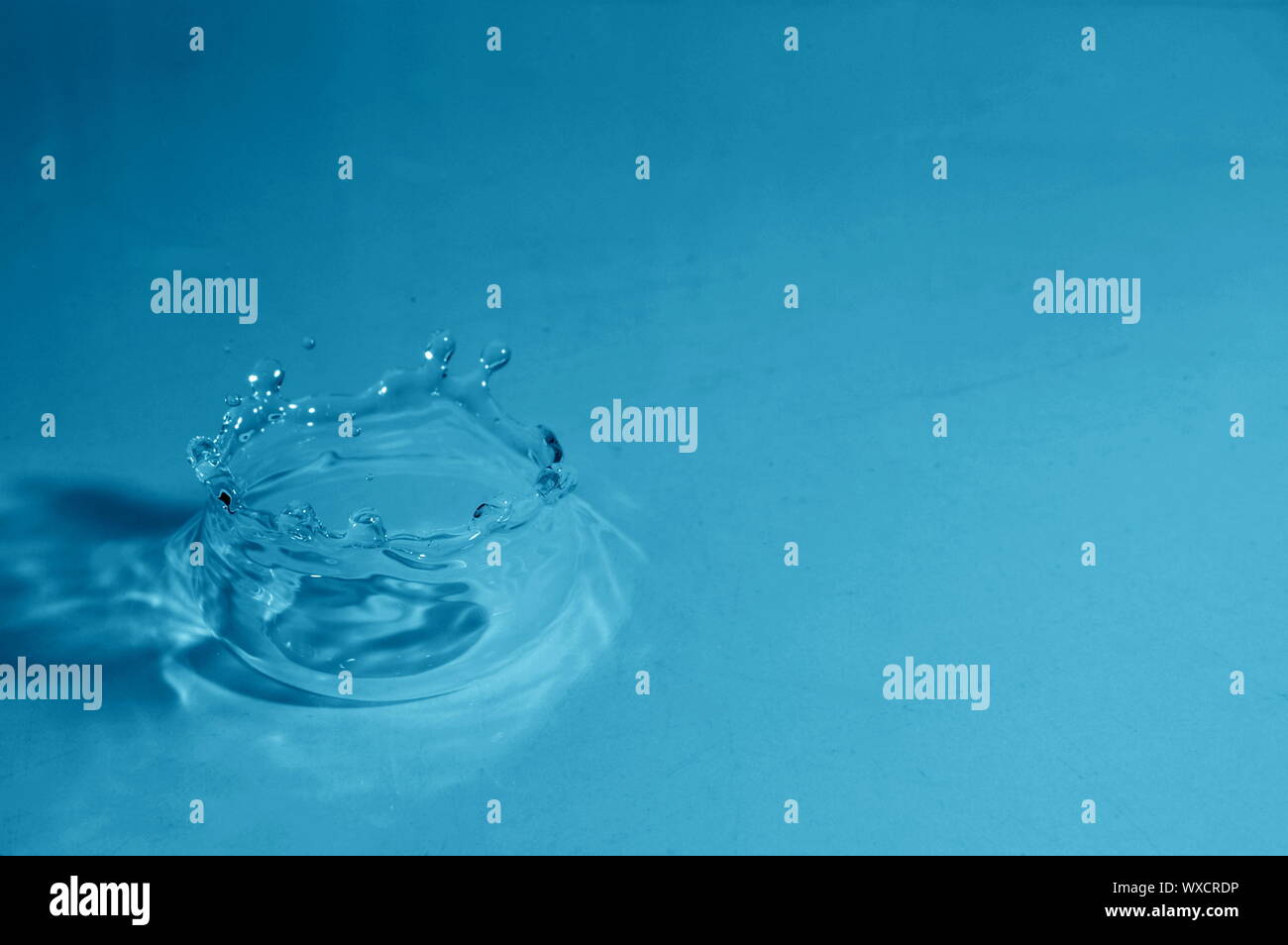 fresh water drop splashing in blue cool water Stock Photo - Alamy