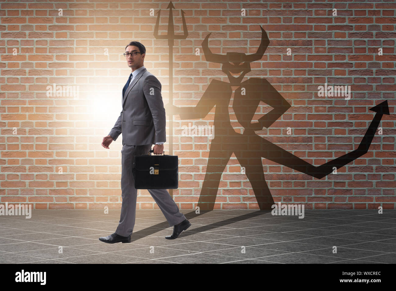 Devil hiding in the businessman - alter ego concept Stock Photo - Alamy