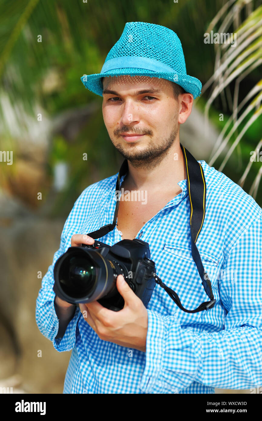 Man on a beach with camera Stock Photo - Alamy
