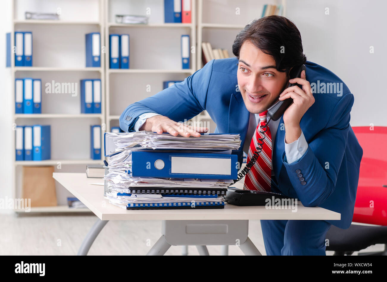 Young happy male employee in the office Stock Photo - Alamy