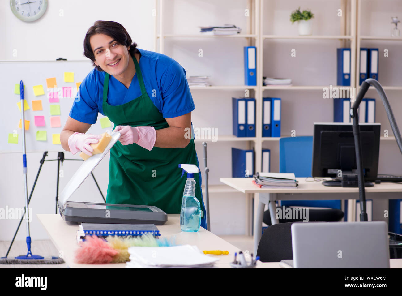 Male handsome professional cleaner working in the office Stock Photo ...