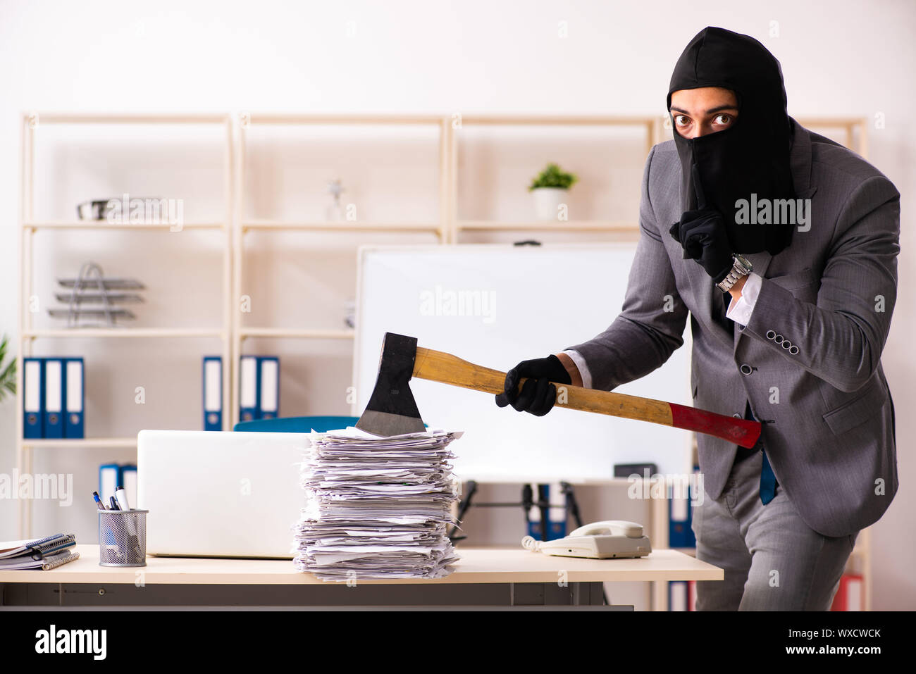 Male gangster stealing information from the office Stock Photo - Alamy