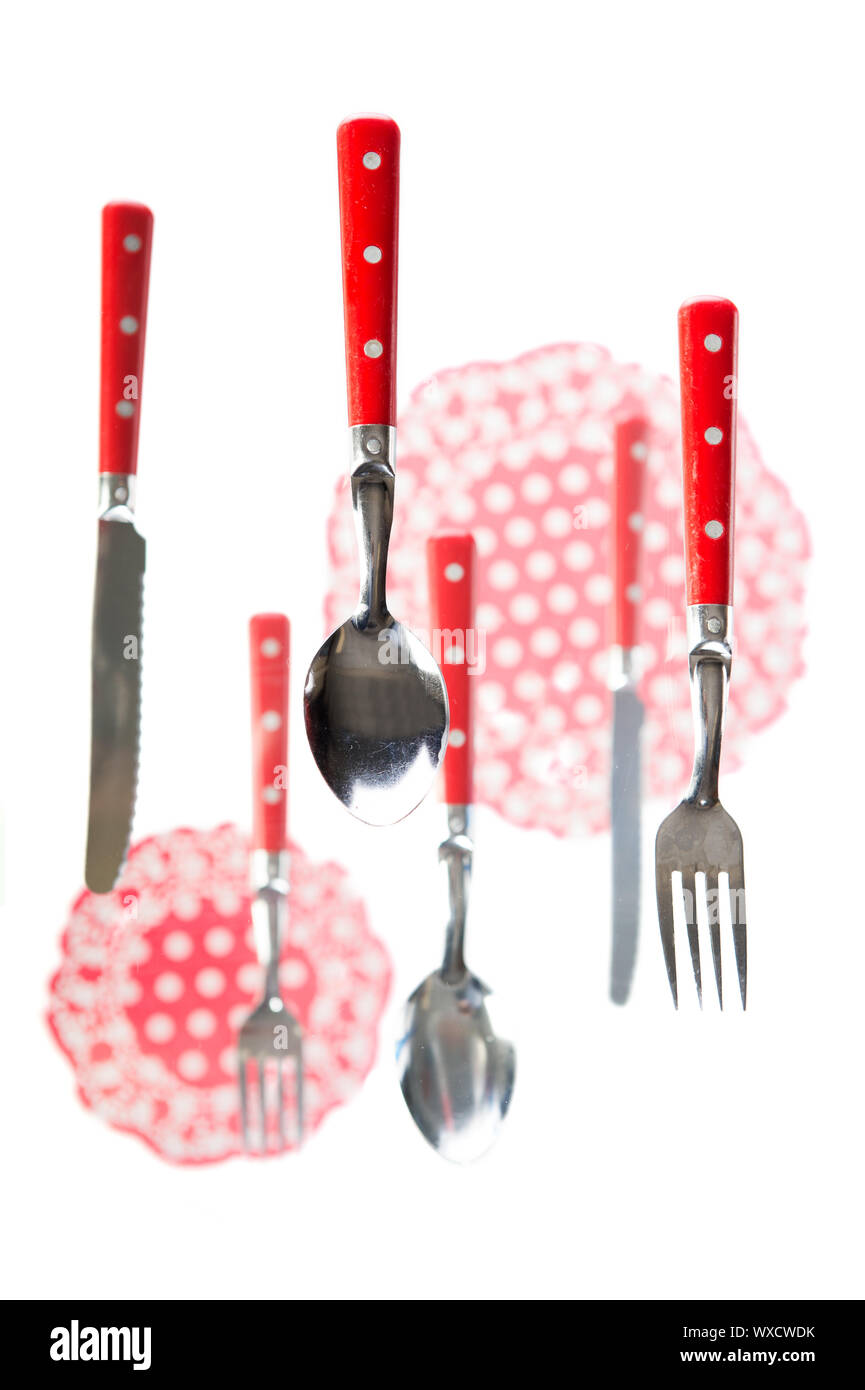 Floating red cutlery and lace cloths Stock Photo - Alamy