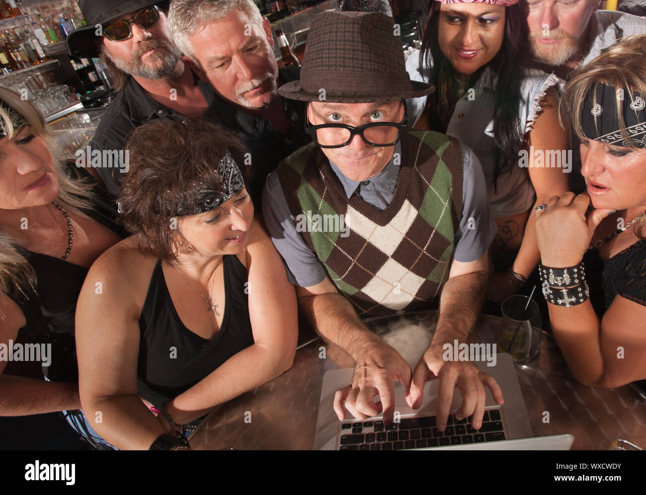 Mature nerd troubleshooting a computer with biker gang Stock Photo - Alamy