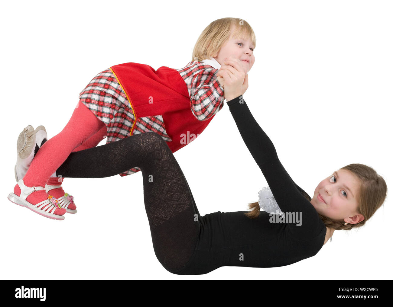 Two little acrobat girls on the white background Stock Photo - Alamy