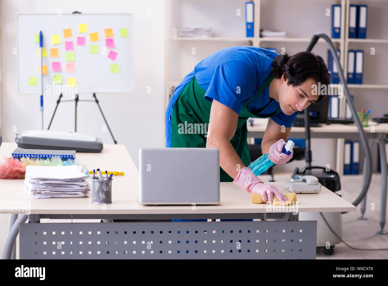 Male handsome professional cleaner working in the office Stock Photo ...