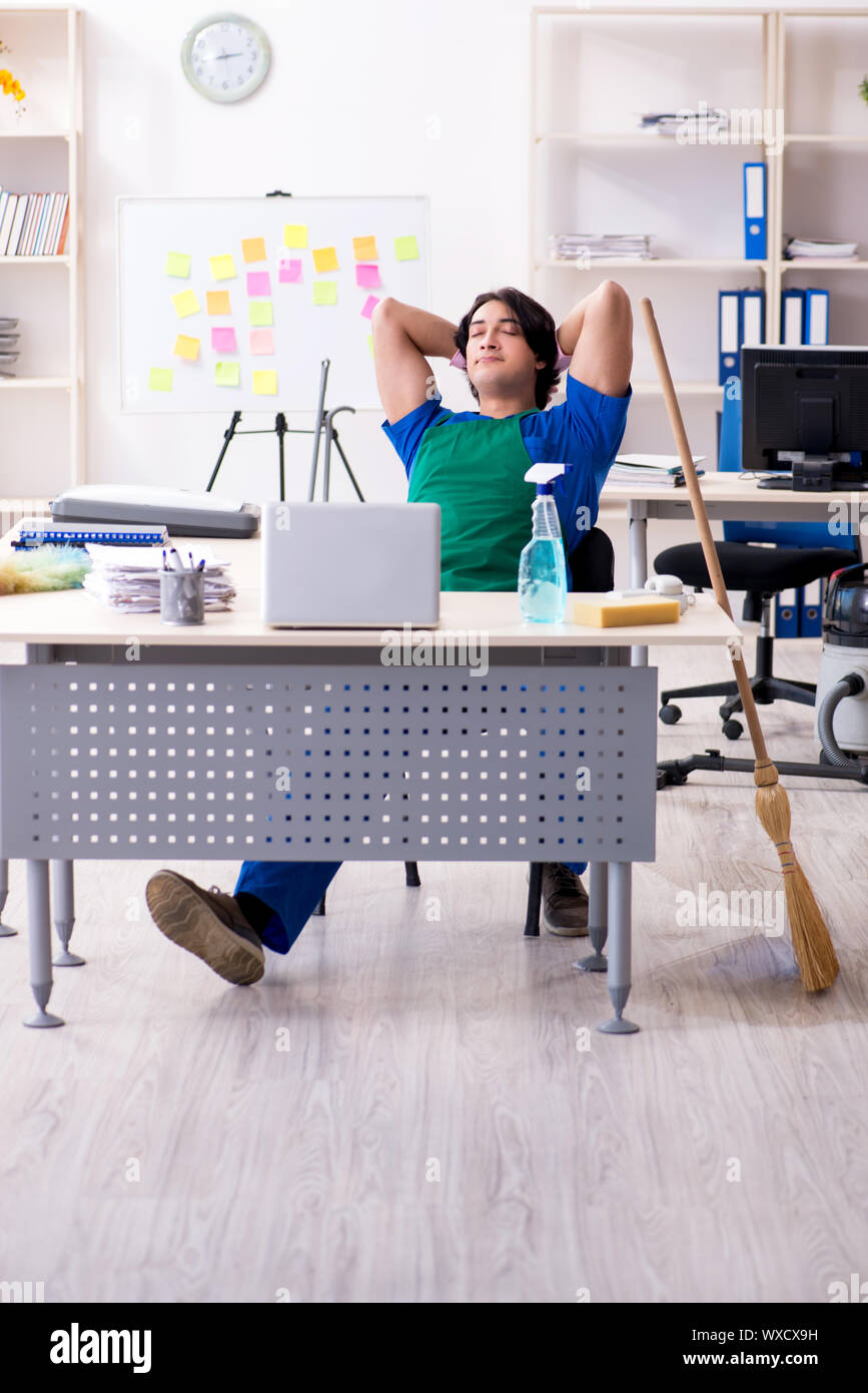 Male handsome professional cleaner working in the office Stock Photo ...