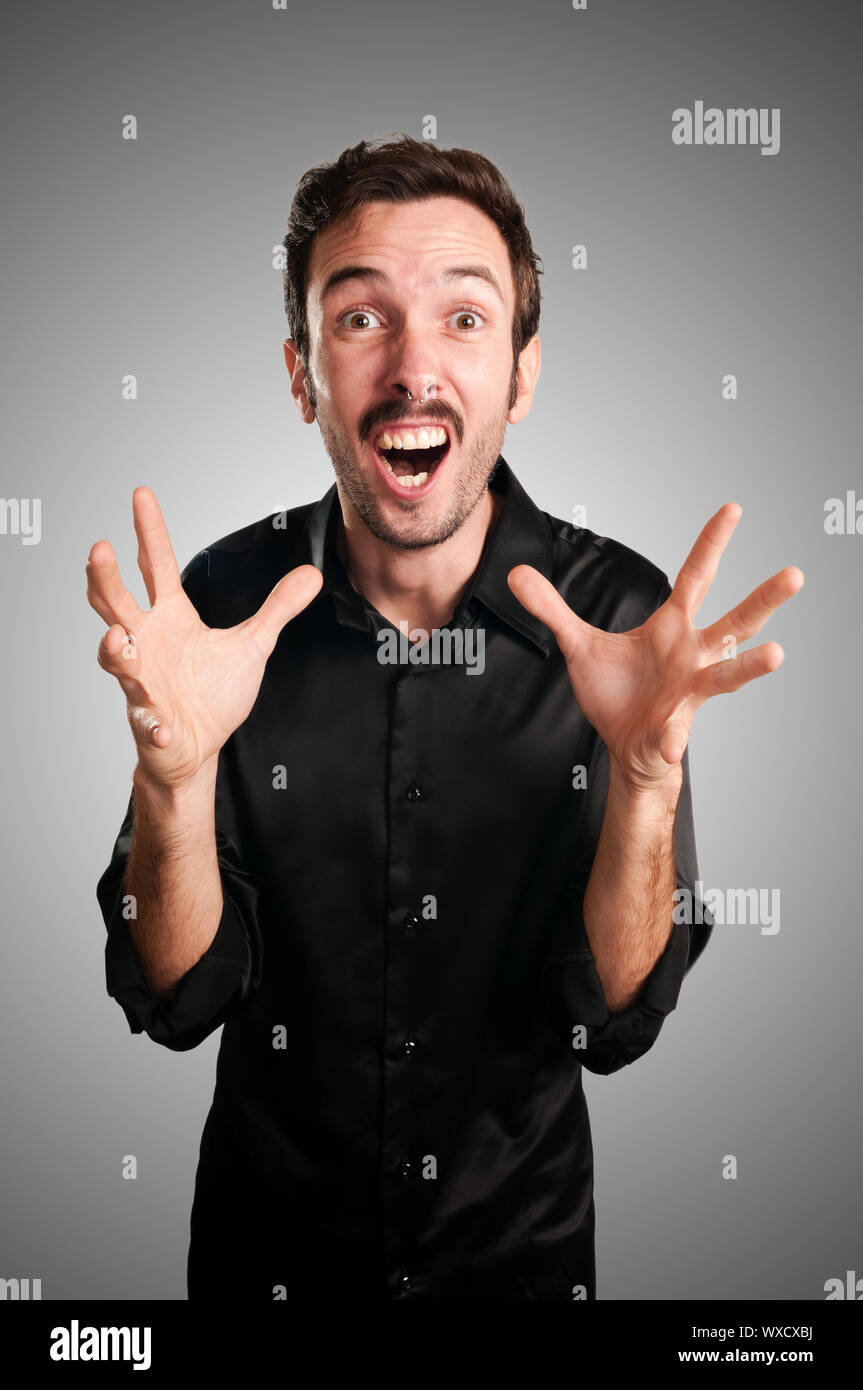 successful business man screaming on blue background Stock Photo - Alamy