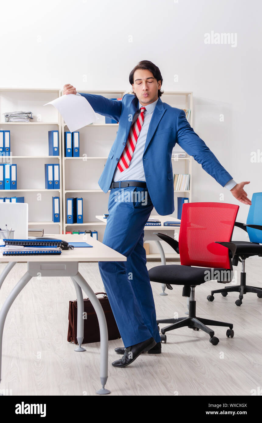 Young happy male employee in the office Stock Photo - Alamy