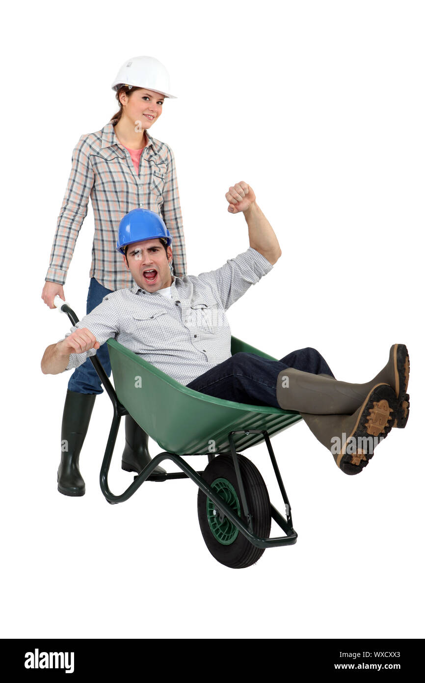 Workers with a wheelbarrow Stock Photo - Alamy