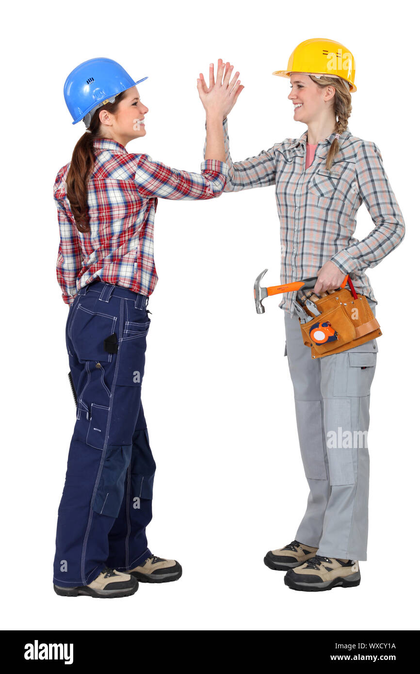 Female construction workers high-fiving Stock Photo - Alamy