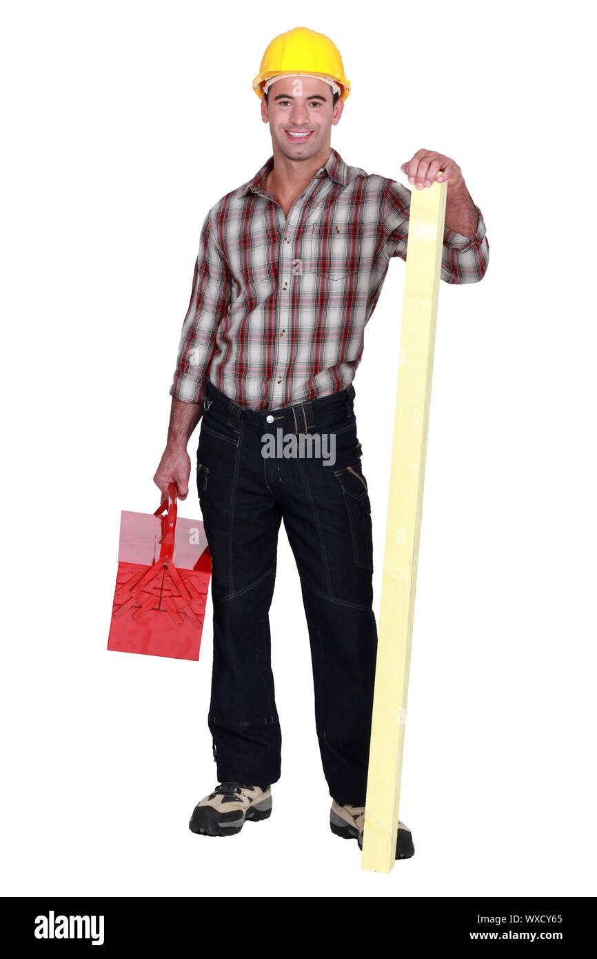 Confident carpenter standing on white background Stock Photo - Alamy