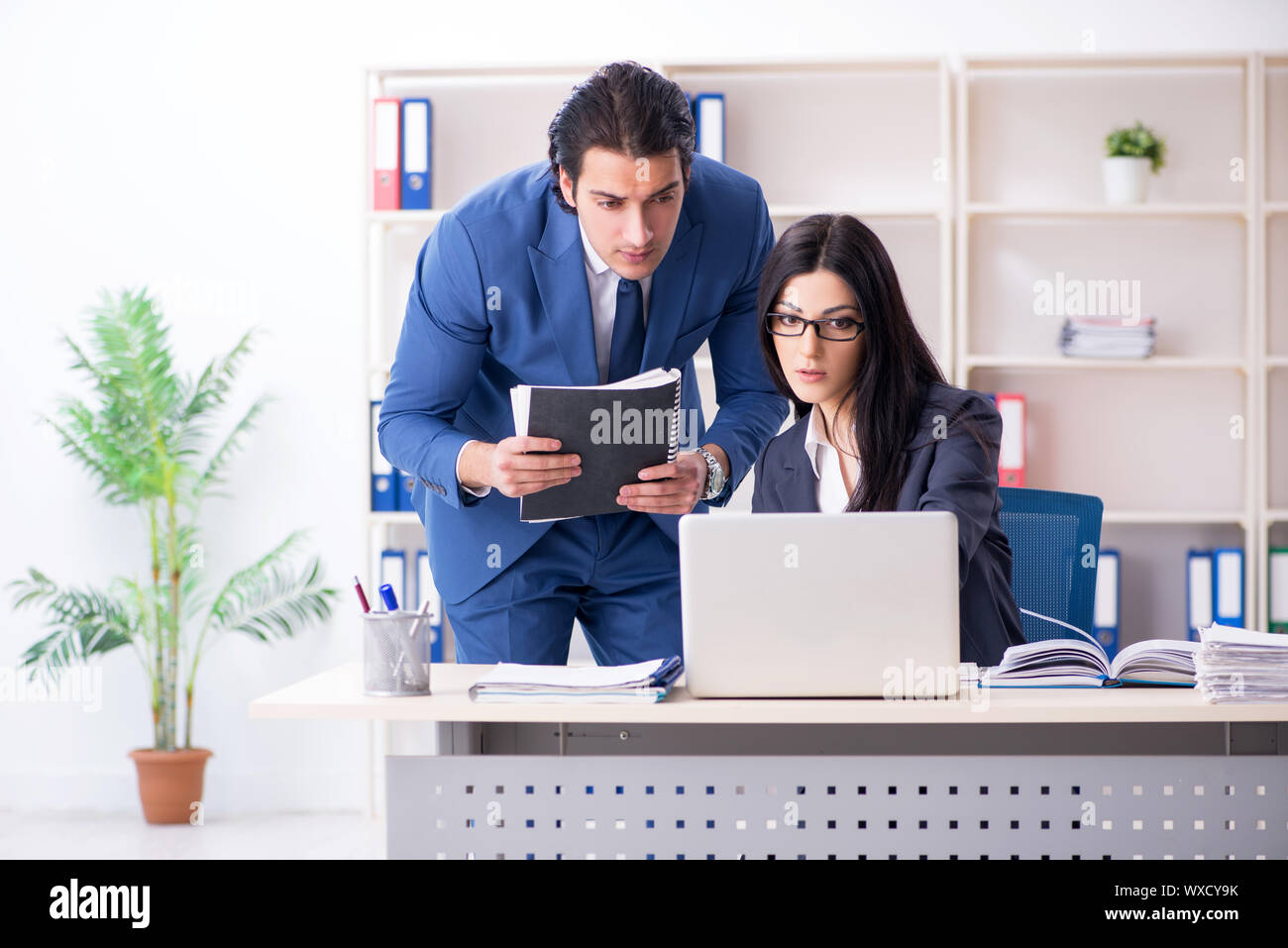 Two employees working in the office Stock Photo - Alamy