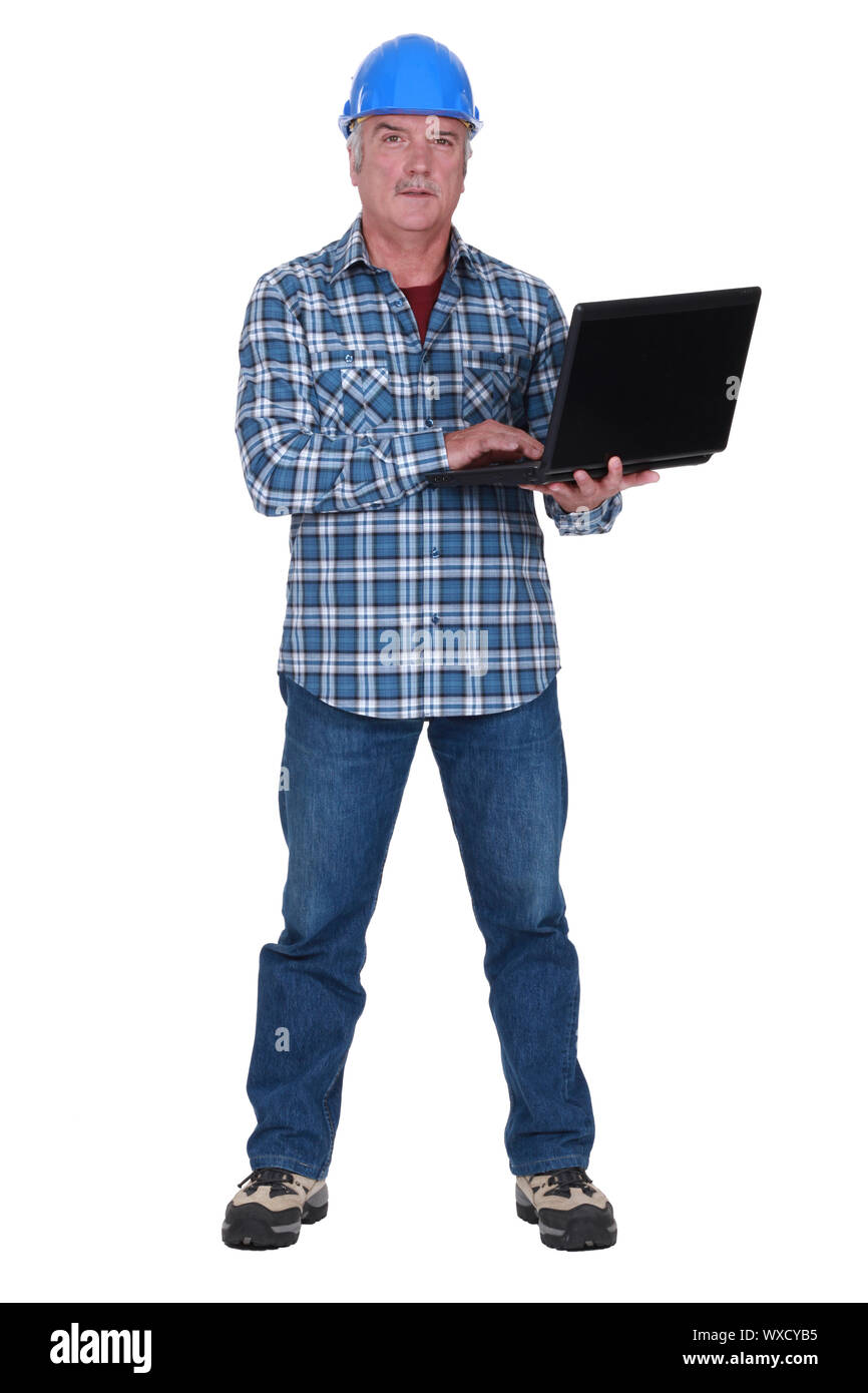 Tradesman holding a laptop Stock Photo - Alamy
