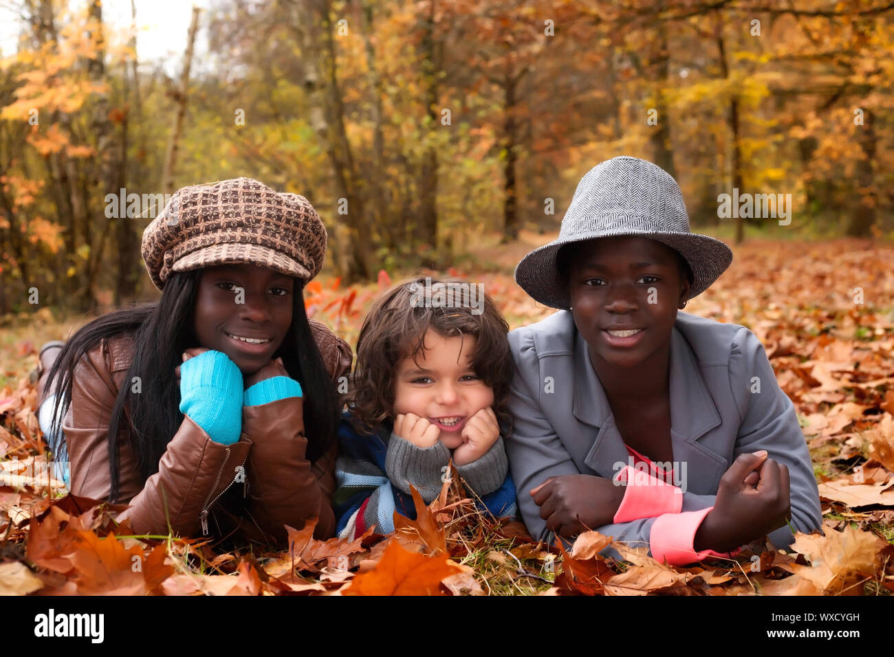 Happy family with foster children in the forest Stock Photo - Alamy