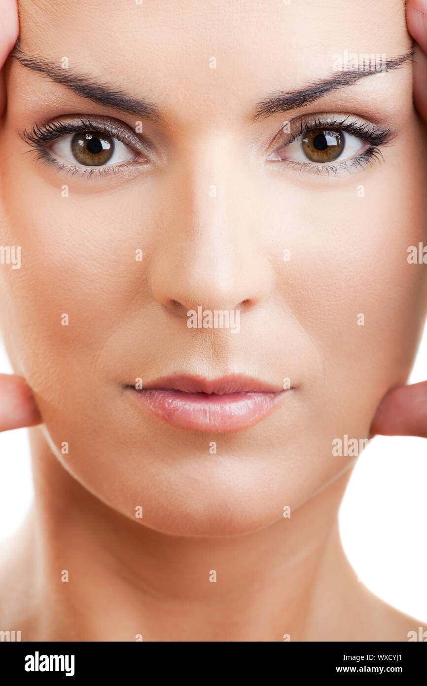 Close-up portrait of a beautiful and fresh woman stretching the face ...