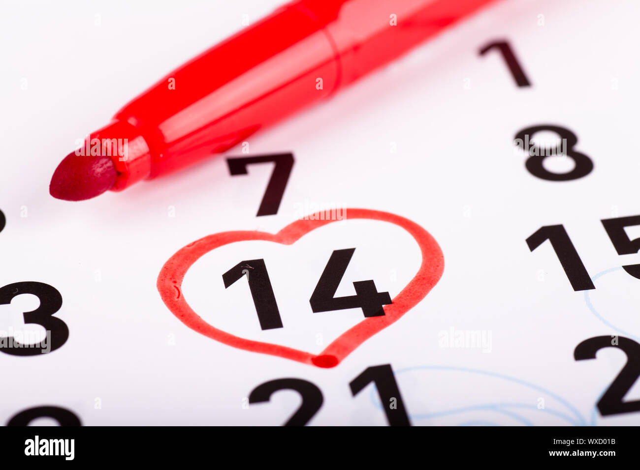 Sheet of wall calendar with red heart shaped mark on Valentines day ...