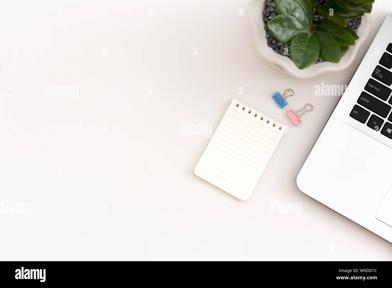 White office desk with notebook and pen Stock Photo - Alamy