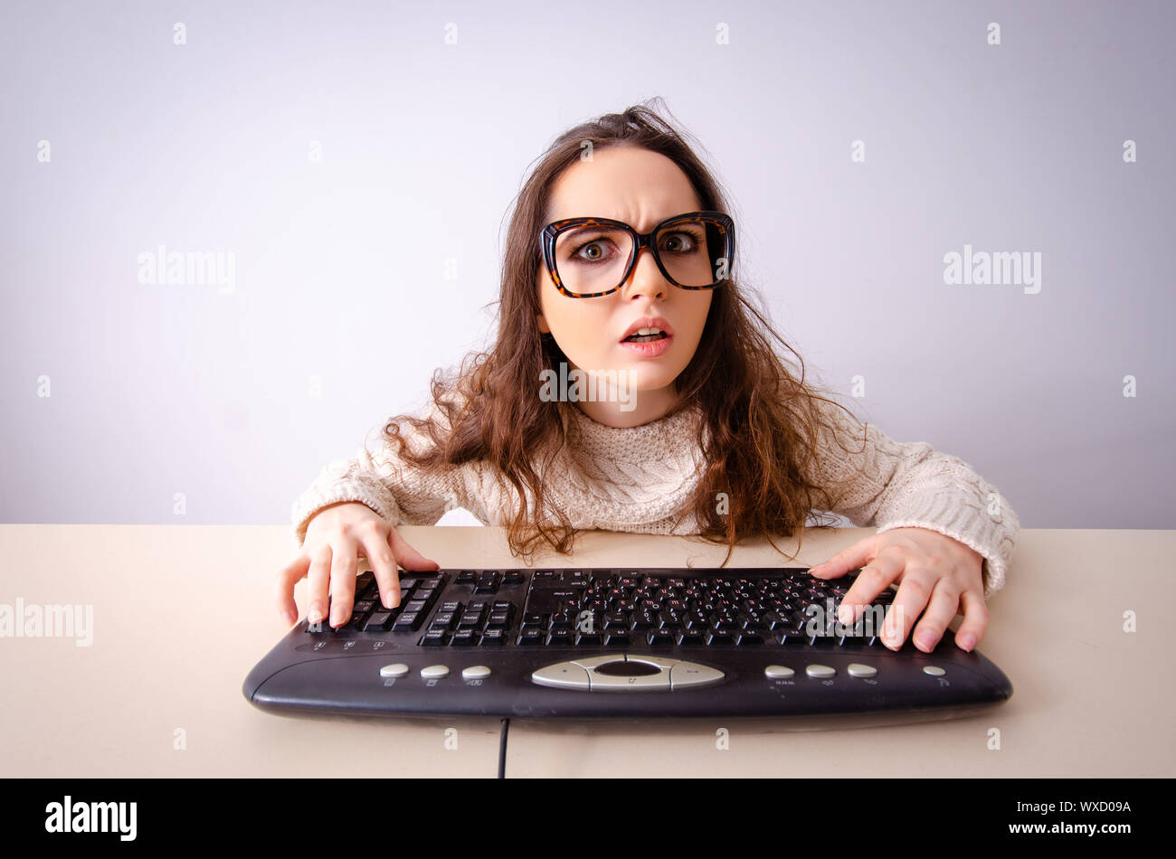 Funny nerd girl working on computer Stock Photo - Alamy