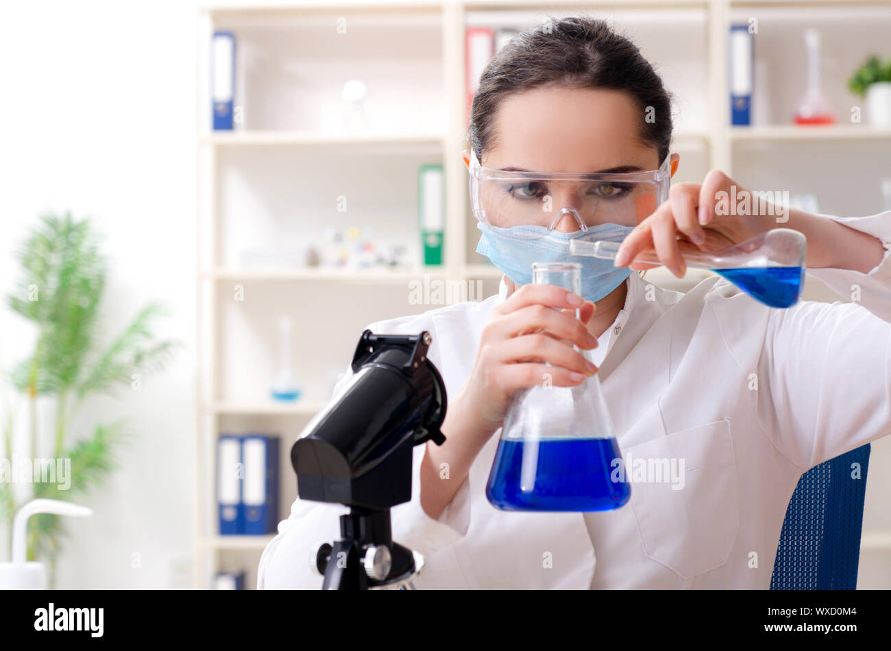Female scientist mixing chemical solution hi-res stock photography and ...