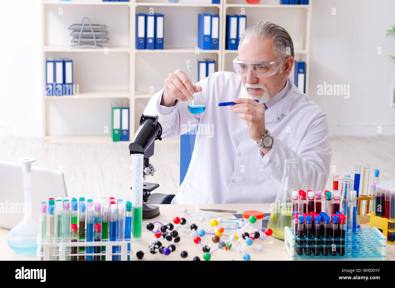 Old male chemist working in the lab Stock Photo - Alamy