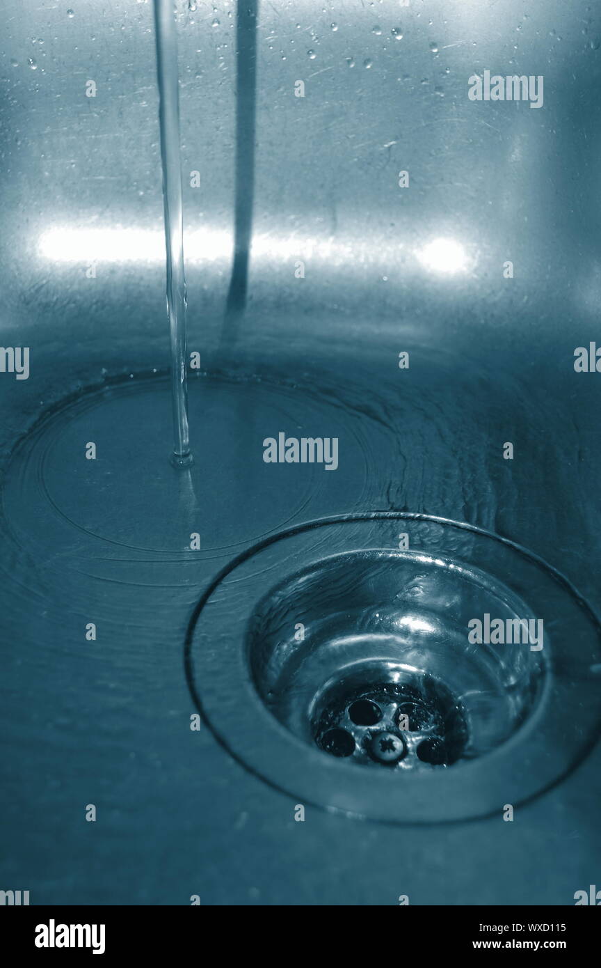 water flow into the drain in the kitchen Stock Photo - Alamy