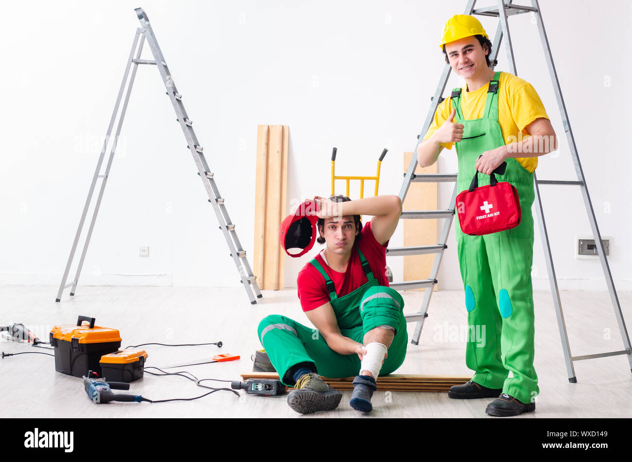 Injured worker and his workmate Stock Photo - Alamy