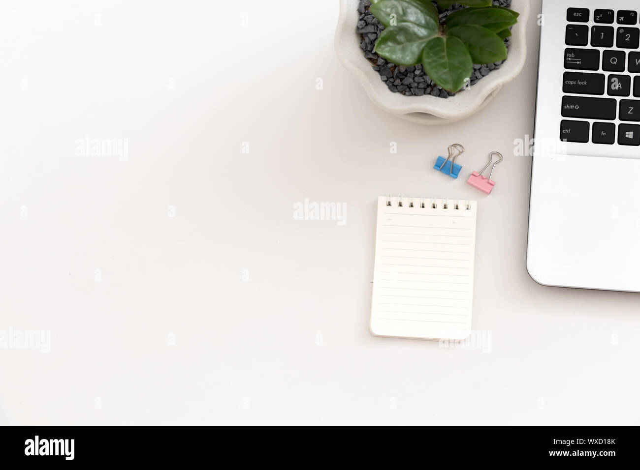 White office desk with notebook and pen Stock Photo - Alamy