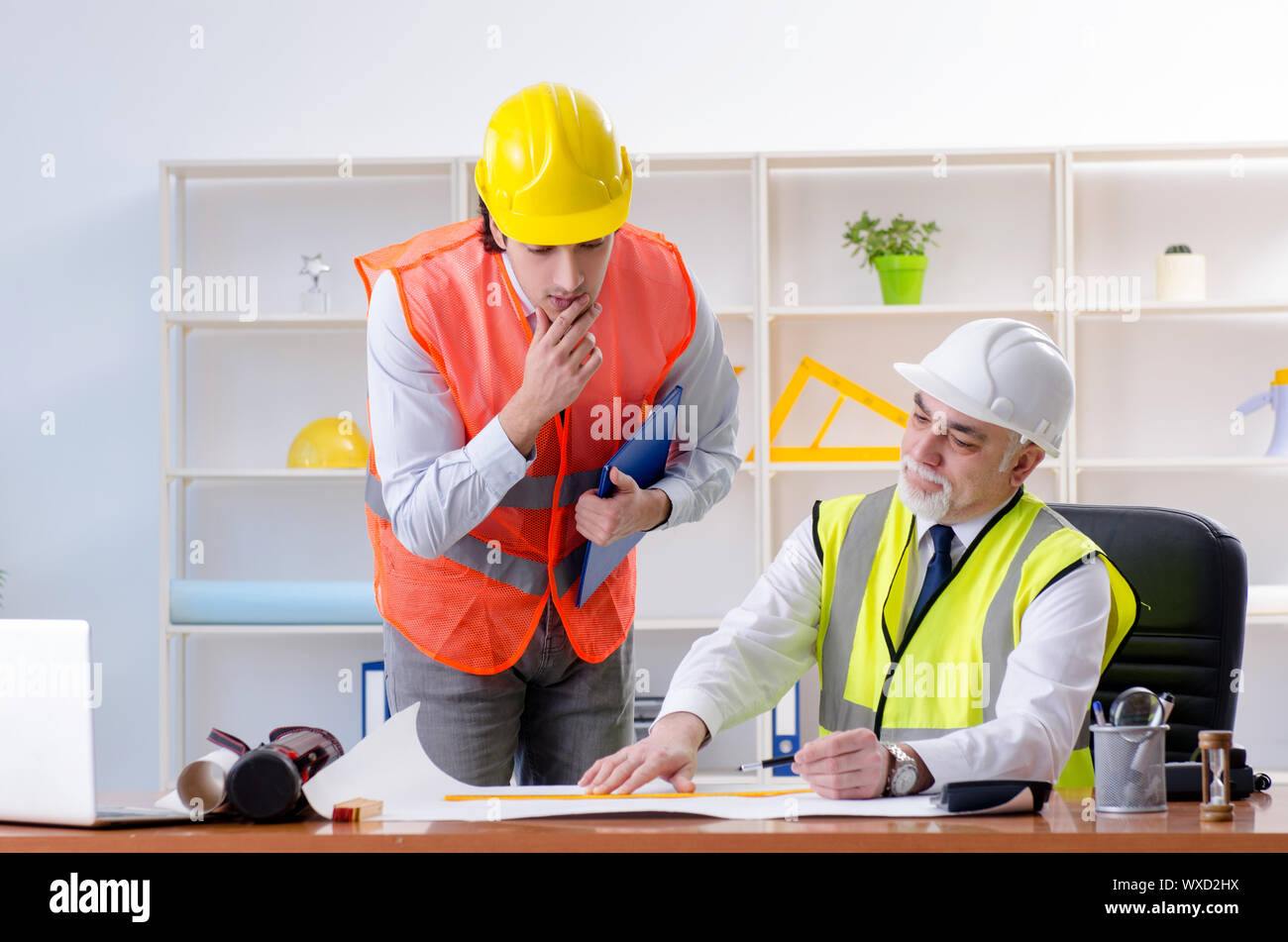 Two engineers colleagues working under project Stock Photo - Alamy