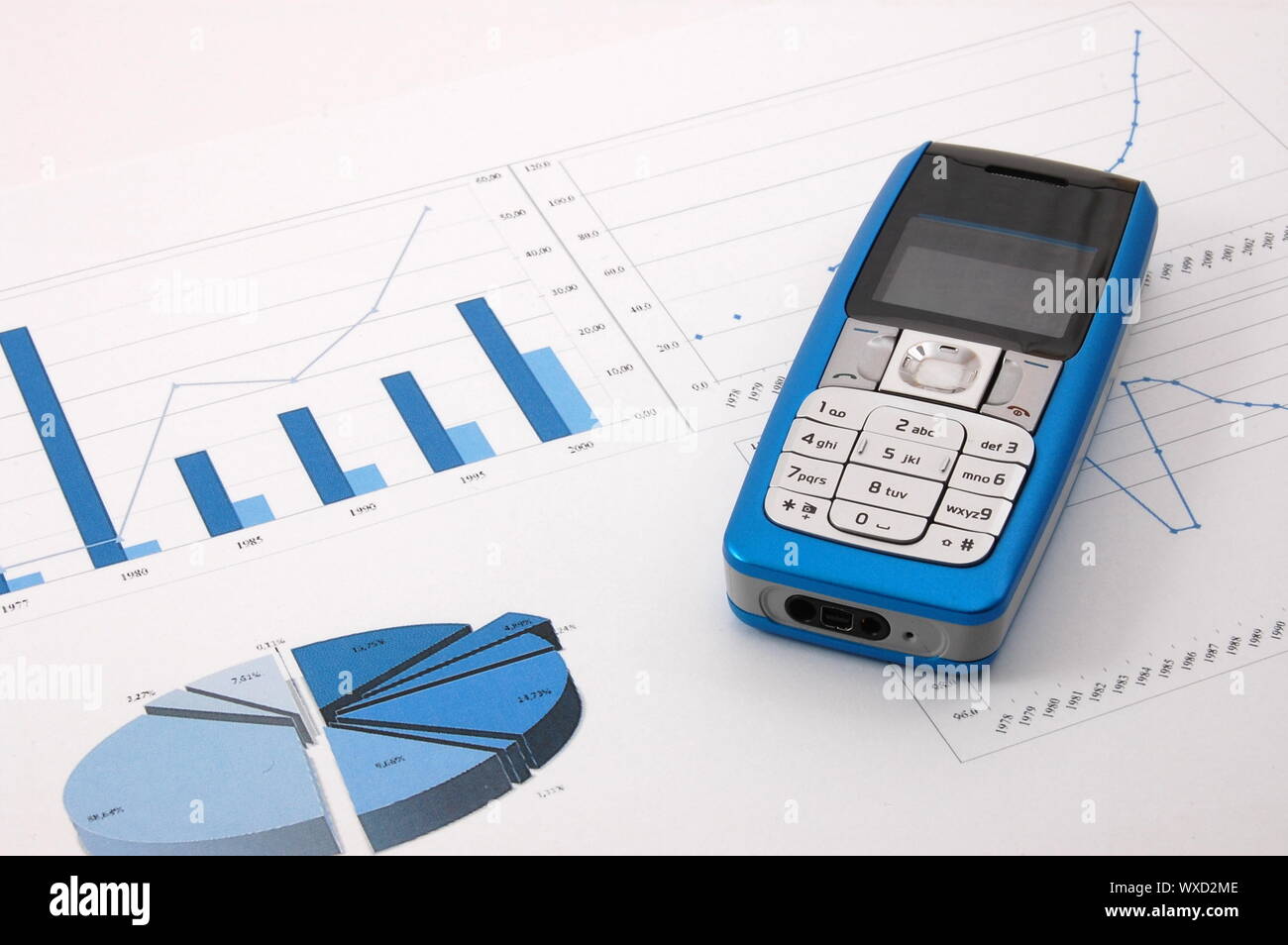 blue cell phone over business chart showing success Stock Photo - Alamy