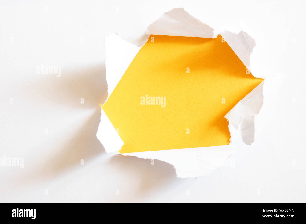 yellow hole in blank sheet paper with copyspace Stock Photo - Alamy