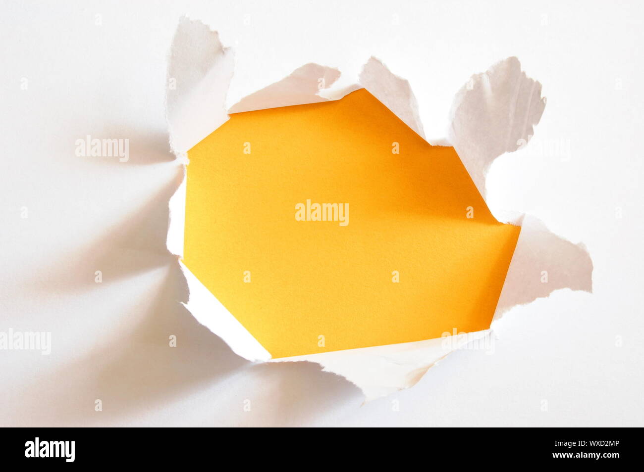 yellow hole in blank sheet paper with copyspace Stock Photo - Alamy