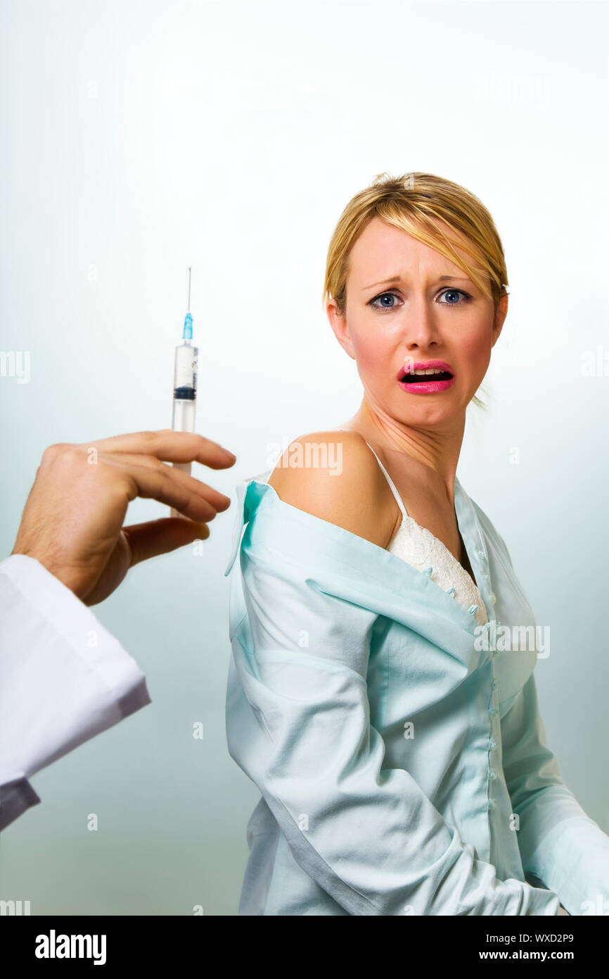 healthcare and medicine: young woman scared of injections Stock Photo ...