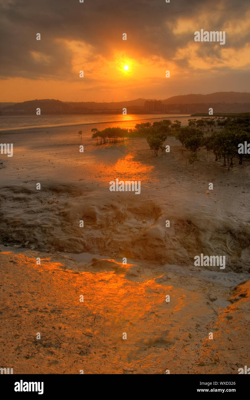 Red sunset landscape of river mud under dramatic sky and sun Stock ...