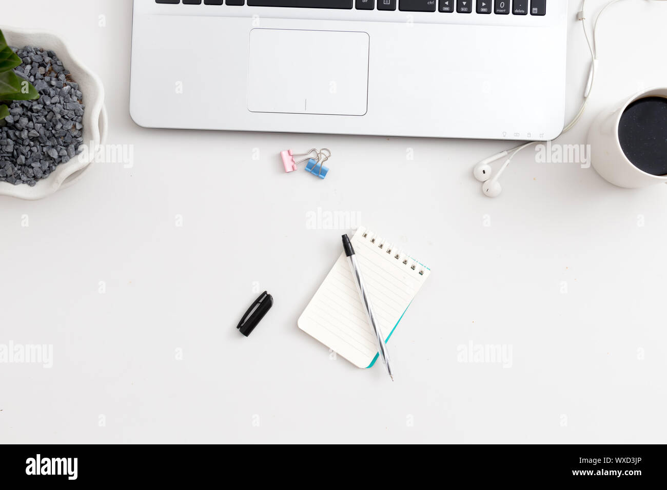 White office desk with notebook and pen Stock Photo - Alamy