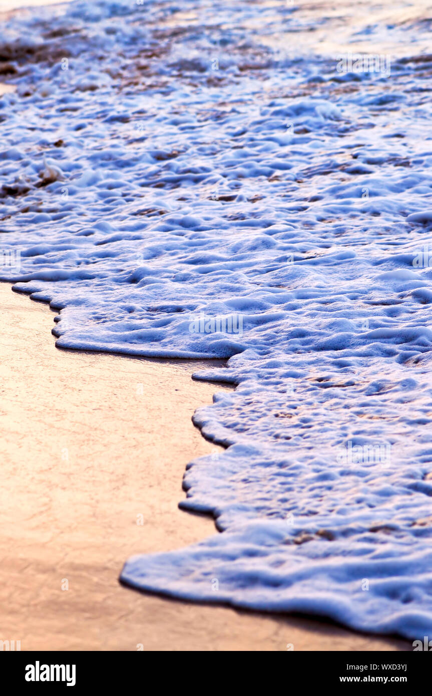 Tropical Caribbean sea waves breaking on the shore Stock Photo - Alamy