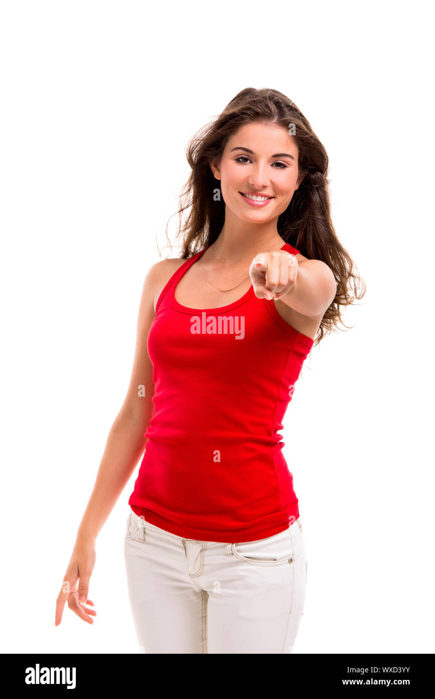 Beautiful young woman pointing to somewhere, isolated over a white ...