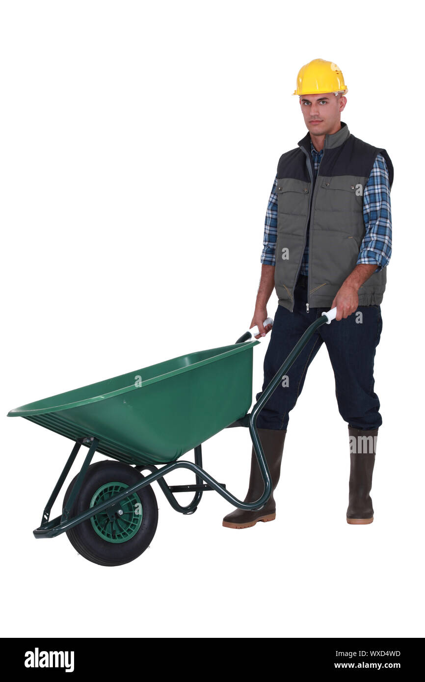 Construction worker with wheelbarrow Stock Photo - Alamy